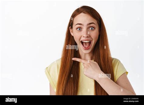 Showing Advertisement Happy Ginger Girl Pointing Finger Left At Logo