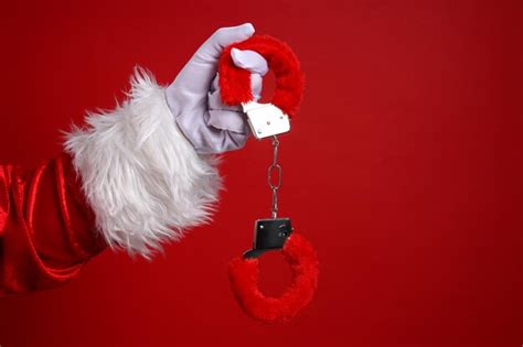 Premium Photo New Year Concept Santas Hand With Handcuffs