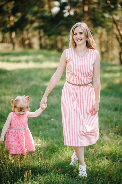 Premium Photo The Mother Runs With A Daughter And Holds Her Hand On