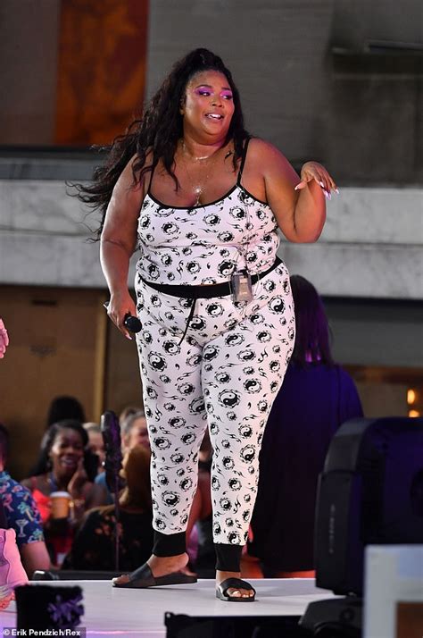 Lizzo Simply Shines In A Gold Bodysuit And Purple Bra For Impressive