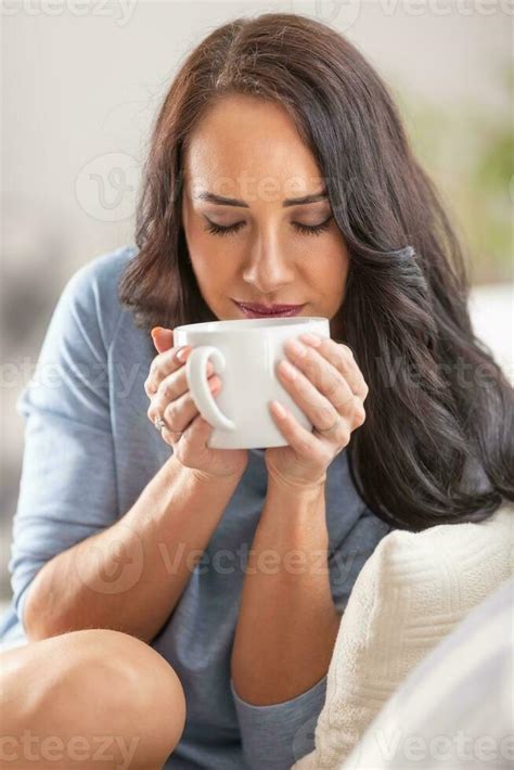 Dark Haired Woman Enjoying A Lovely Cup Of Tea Or Coffee While Sitting