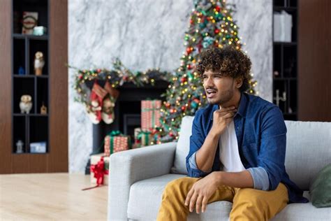 Premium Photo A Man Has A Sore Throat For Christmas Hispanic Sits