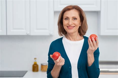 Free Photo Portrait Of Happy Woman Holding Tomatoes