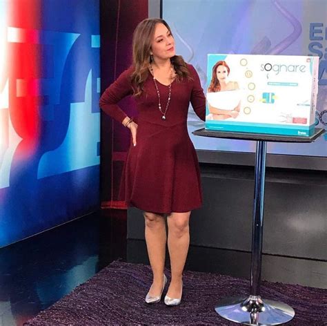 A Woman Is Standing In Front Of A Television Screen With Her Hands On