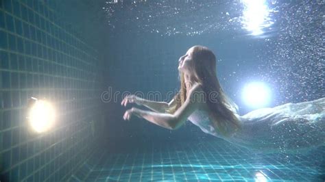 Beautiful Woman With Long Red Hair Swimming Underwater In Dress Stock