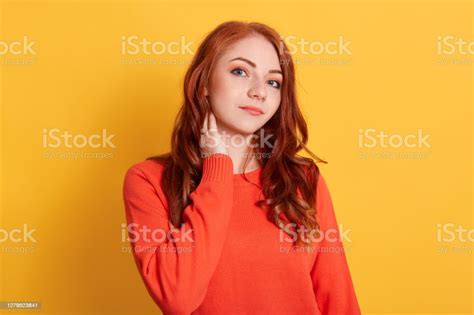 Beautiful Ginger Girl Keeps Hand On Neck Being In High Spirit Poses