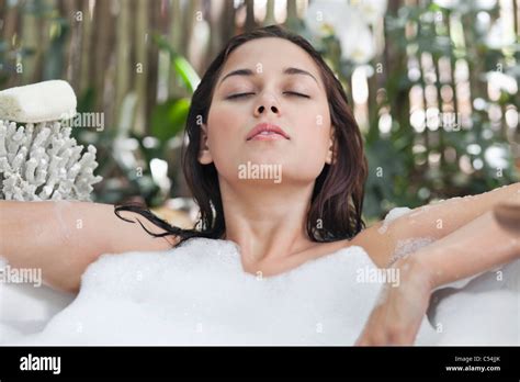 Beautiful Young Woman Taking Bubble Bath With Her Eyes Closed Stock