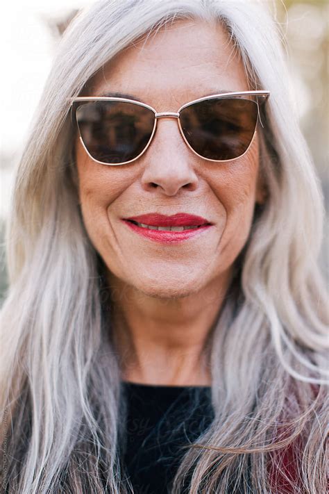 Closeup Portrait Of A Mature Woman With Grey Hair Wearing Sunglasses