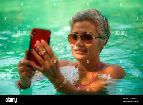Attractive And Happy Middle Aged Asian Indonesian Woman In Bikini