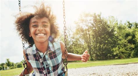 African Girl Portrait And Smile With Playground Swing And Nature For