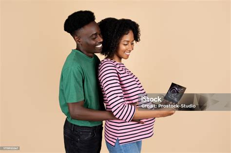 Glad Millennial African American Husband Hug Wife With Big Belly Enjoy