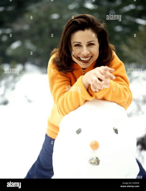 Female Shoulder Length Brunette Hair Wearing Orange Fleece Jacket And