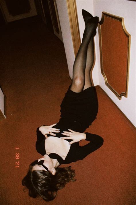A Woman Is Laying On The Floor With Her Legs Spread Out And Wearing