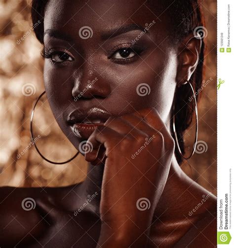 Close Up Portrait Of Beautiful African Woman With Creative Gold Make Up