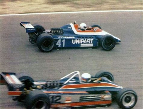 Two Race Cars Racing On The Track