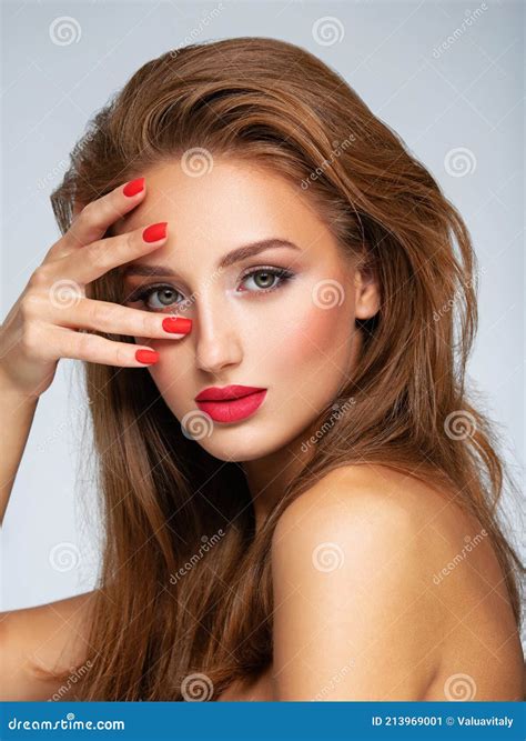 Face Of Young Woman With Red Nails Lipstick And Long Brown Hair Model