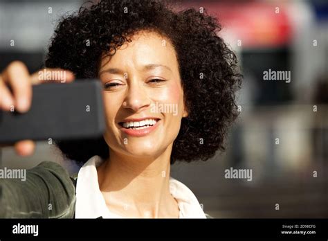 Close Up Portrait Of Smiling African American Woman Taking Selfie With