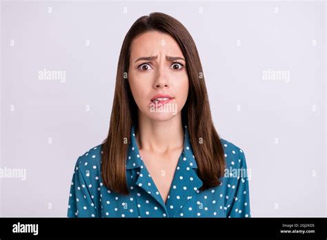 Photo Of Impressed Guilty Young Woman Dressed Blue Blouse Biting Lip