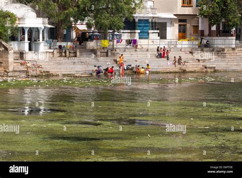 Indian Women Bathing And Washing Clothes On The Banks Of Lake Pichola