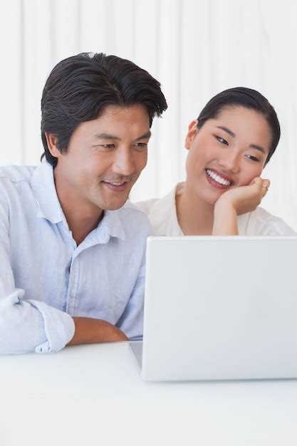 Premium Photo Happy Couple Using Laptop Together