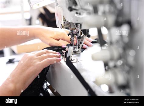 Sewing Seamstress On The Machine Production Of Clothes Sewing On A