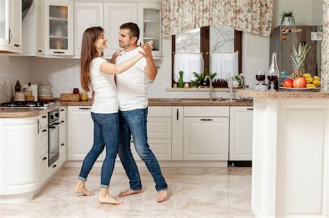 Premium Photo Young Couple Dancing In Kitchen