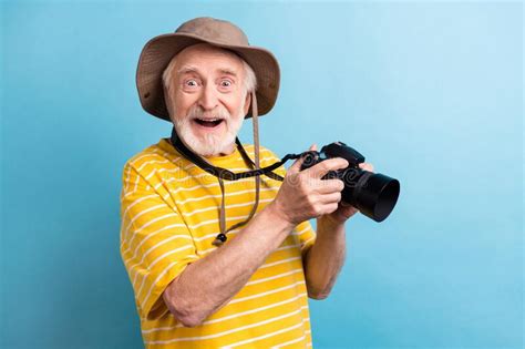 Photo Of Happy Amazed Cheerful Old Man Hold Camera Good Mood Take