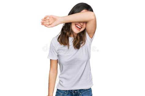 Young Beautiful Woman Wearing Casual White T Shirt Covering Eyes With