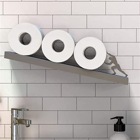 Three Rolls Of Toilet Paper Sitting On Top Of A Shelf Above A Sink In A