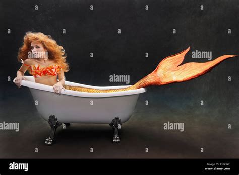 Young Mermaid Laying Underwater In Her Victoria Albert Bathtub Stock