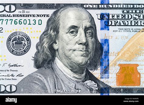 Close Up Overhead View Of Benjamin Franklin Face On 100 Us Dollar Bill
