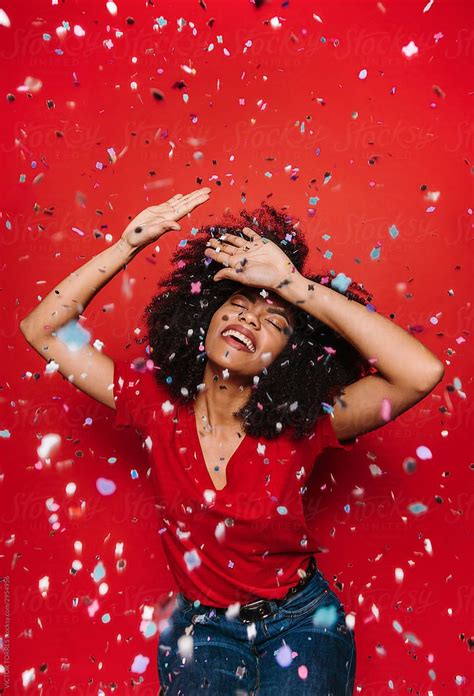 Beautiful Afro Woman Posing Over Red Background By Stocksy