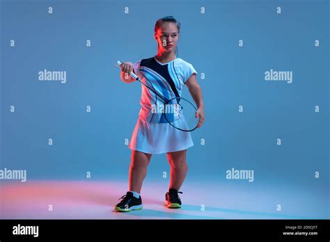 Dynamic Beautiful Dwarf Woman Practicing In Badminton Isolated On Blue