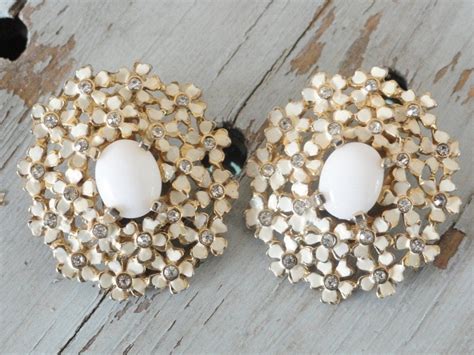 Tiny White Flowers With Rhinestones Surrounding White Milk Glass