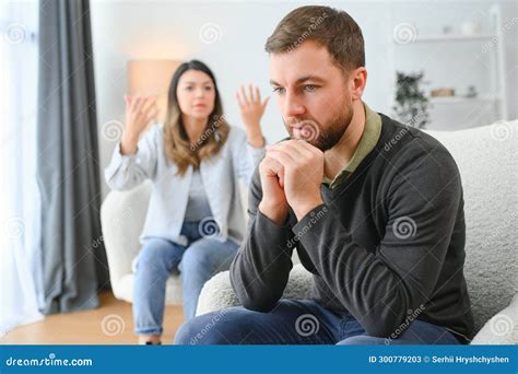 Couple Arguing Wife Shouting To Her Desperate Husband Sitting On A