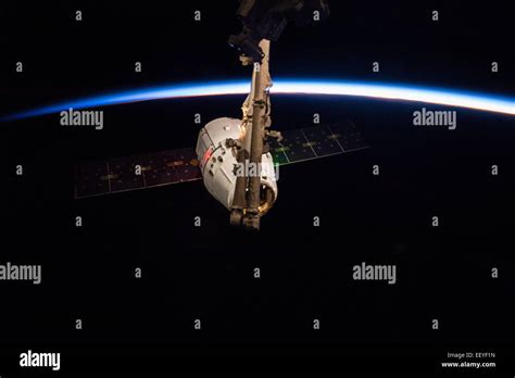 The International Space Stations Canadarm 2 Pulls The Spacex Dragon