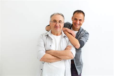 Premium Photo Senior Father With Adult Son On A White Wall