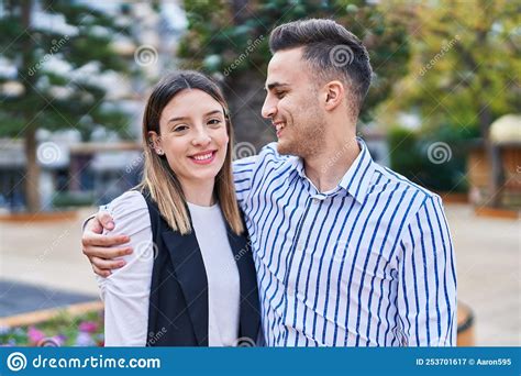 Man And Woman Couple Smiling Confident Hugging Each Other At Park Stock