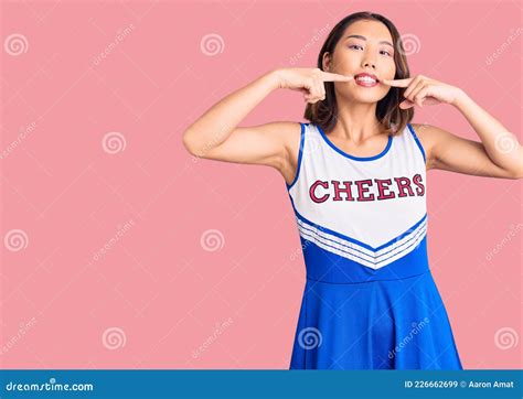 Young Beautiful Chinese Girl Wearing Cheerleader Uniform Smiling