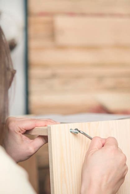 Premium Photo Close Up Of Woman Assembling Wood At Home