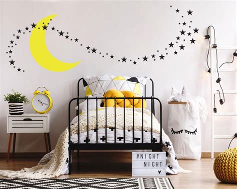 A Bedroom With Stars And Moon Decals On The Wall