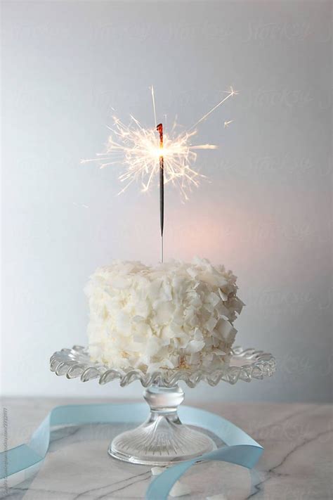 White Chocolate Cake With Sparkler And Blue Ribbon By Stocksy