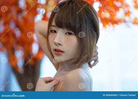 Portrait Of Young Pretty Asian Woman Wearing White Bikini In Her Room