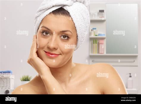 Portrait Of A Young Woman With A Towel On Her Head In A Bathroom Stock