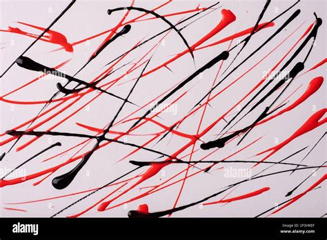 Thin Red And Black Lines And Splashes Drawn On White Background
