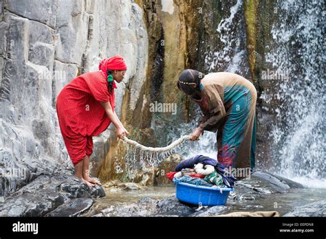 Women Doing Laundry In The Waterfall Near The Village Of Abala