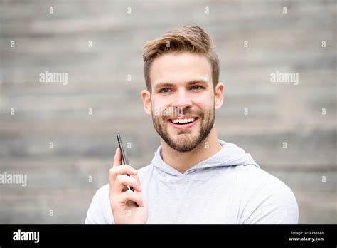 Man With Beard Walks With Smartphone Urban Background With Stairs Man
