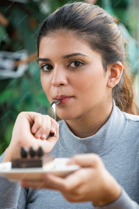 Free Photo Flirty Woman Eating Cake And Looking At Camera
