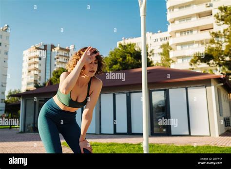 Young Beautiful Redhead Woman Wearing Sportive Clothes On Standing City