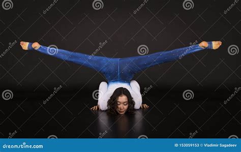 Girl Acrobat Gymnastics A Young Athlete In A Blue And White Suit